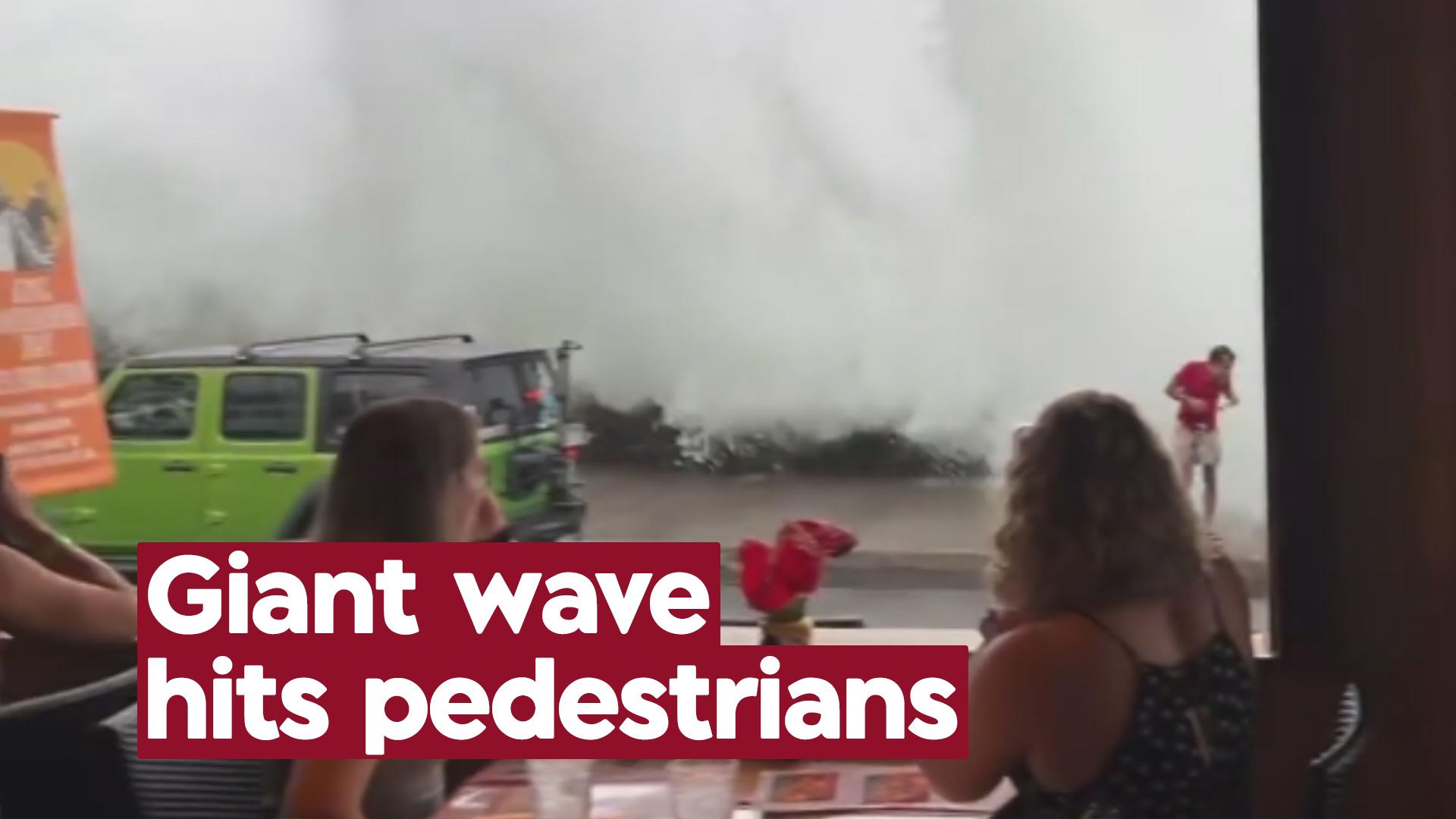Watch: Moment enormous waves crash over Hawaii pedestrians, diners